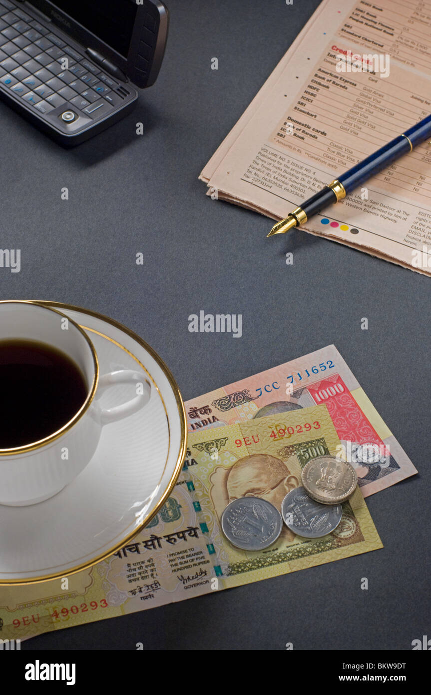Coffee with indian rupees and financial section of newspaper Stock ...