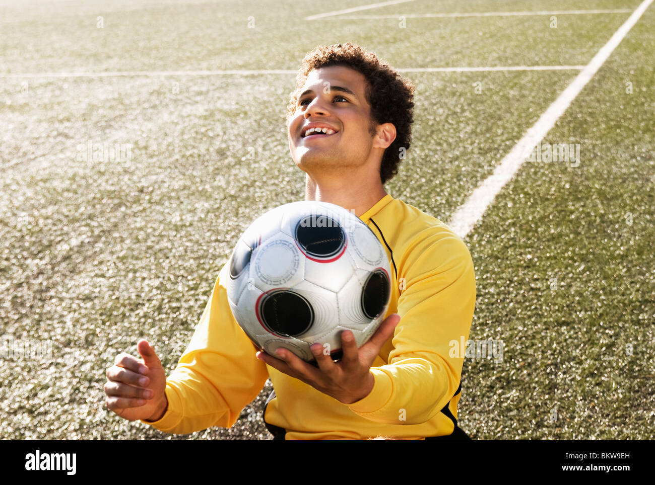 Guy with football Stock Photo - Alamy