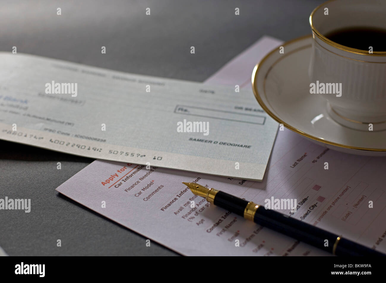Bank check and car loan application form with coffee cup Stock Photo ...