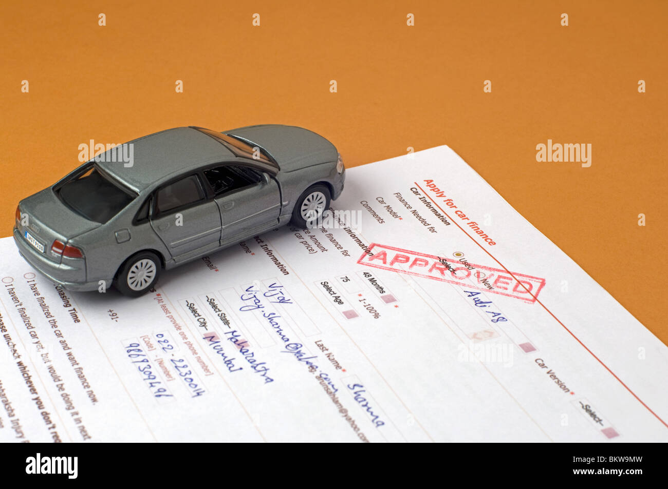 Toy car and application form Stock Photo - Alamy