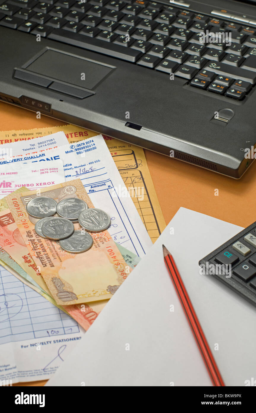 Bills with money and computing devices Stock Photo - Alamy