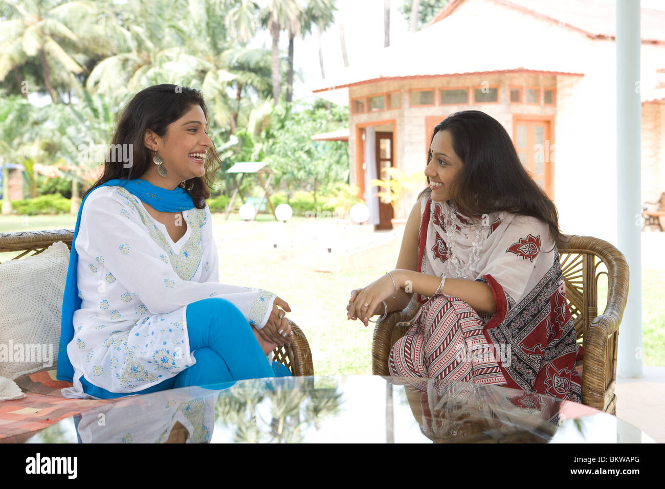 Two women talking in the garden Stock Photo - Alamy