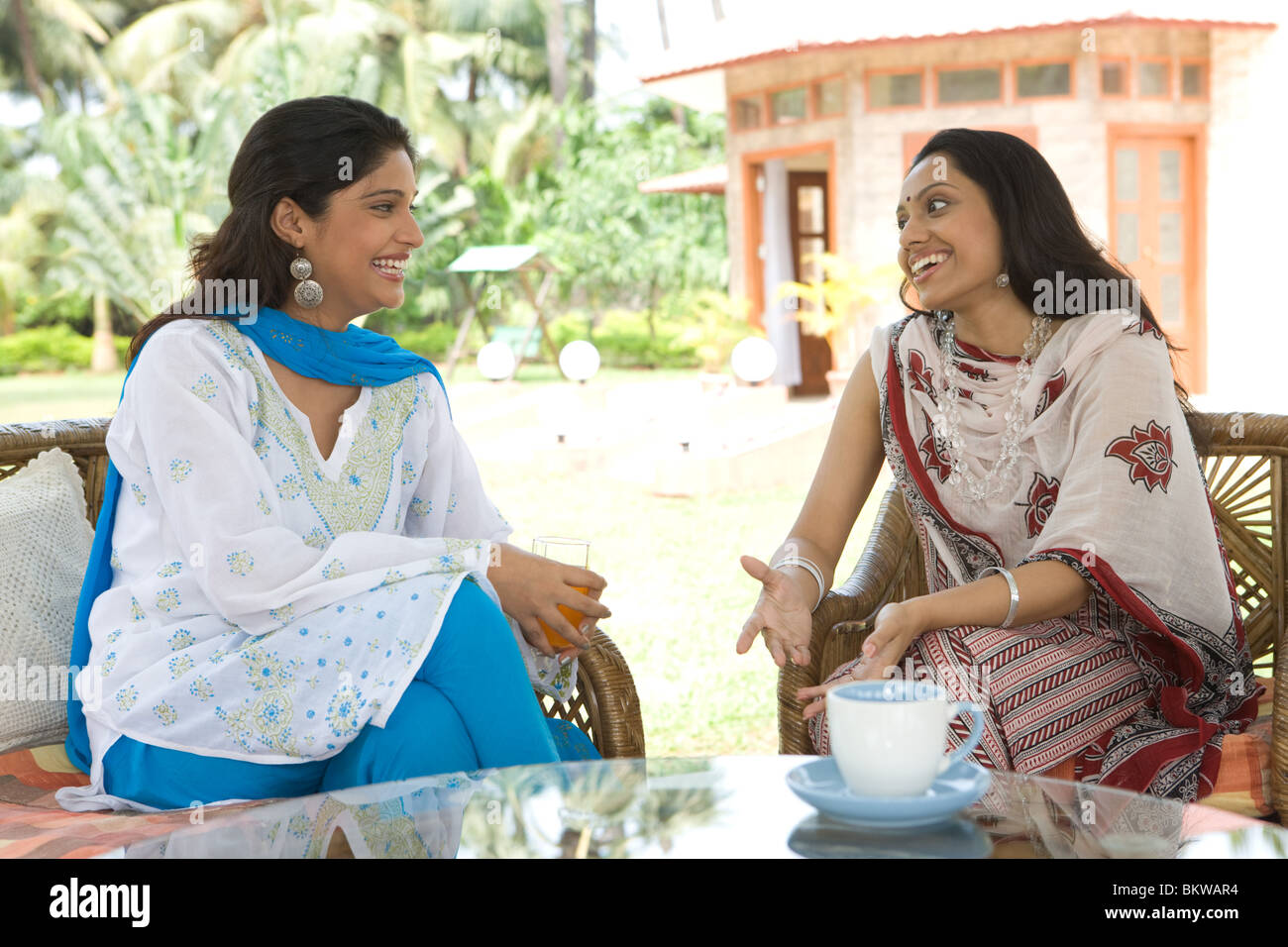 Two women talking in the garden Stock Photo - Alamy