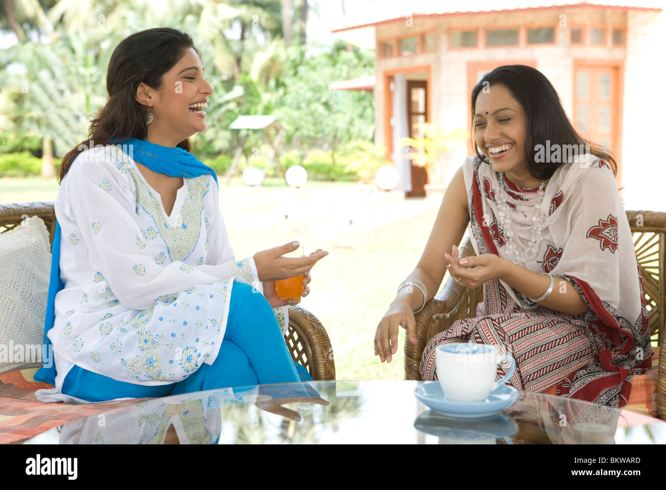 Two women talking in the garden Stock Photo - Alamy