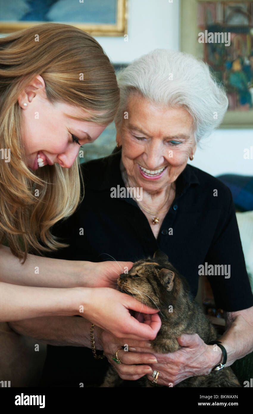 Two people cuddle with cat Stock Photo - Alamy