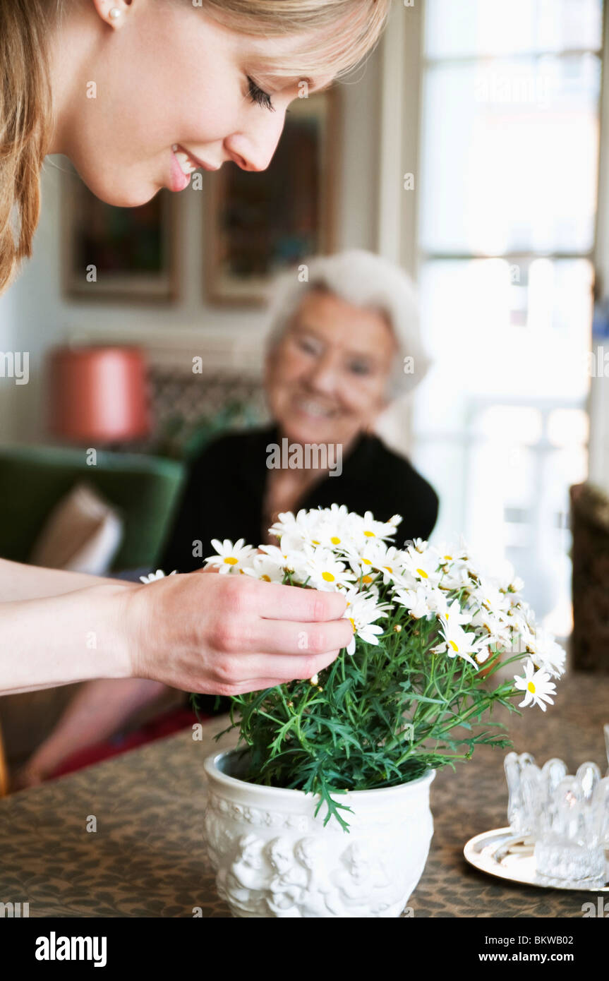 Woman taking care of flowers Stock Photo - Alamy