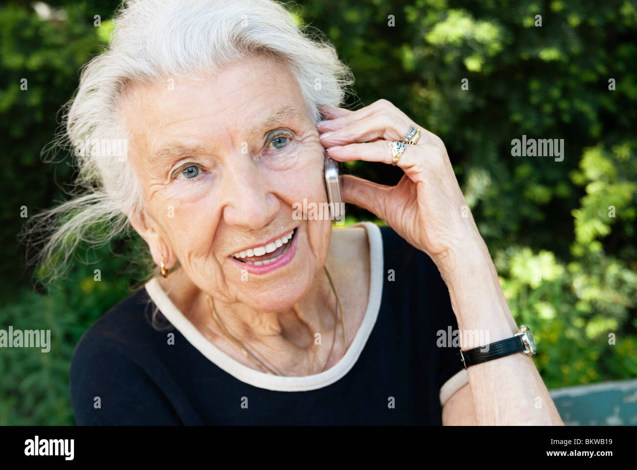 Elderly woman talking in phone Stock Photo - Alamy