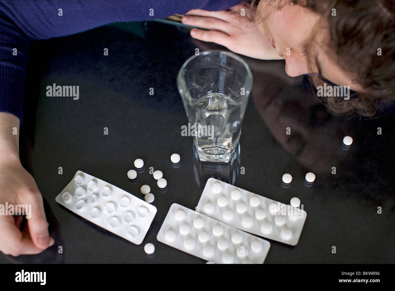 Young person overdosing on tablets, London MODEL RELEASED Stock Photo ...