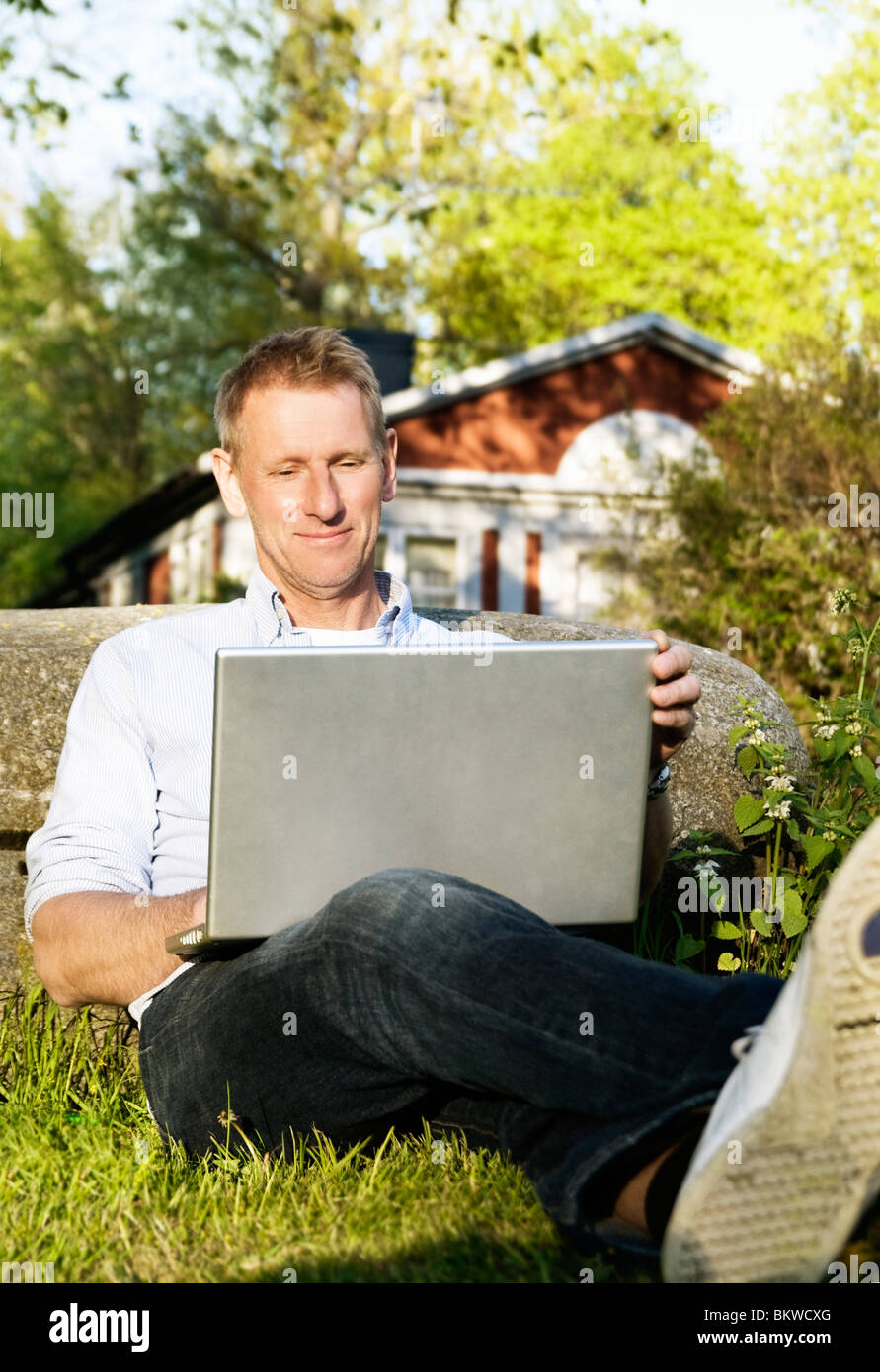 Man sitting outside working Stock Photo - Alamy