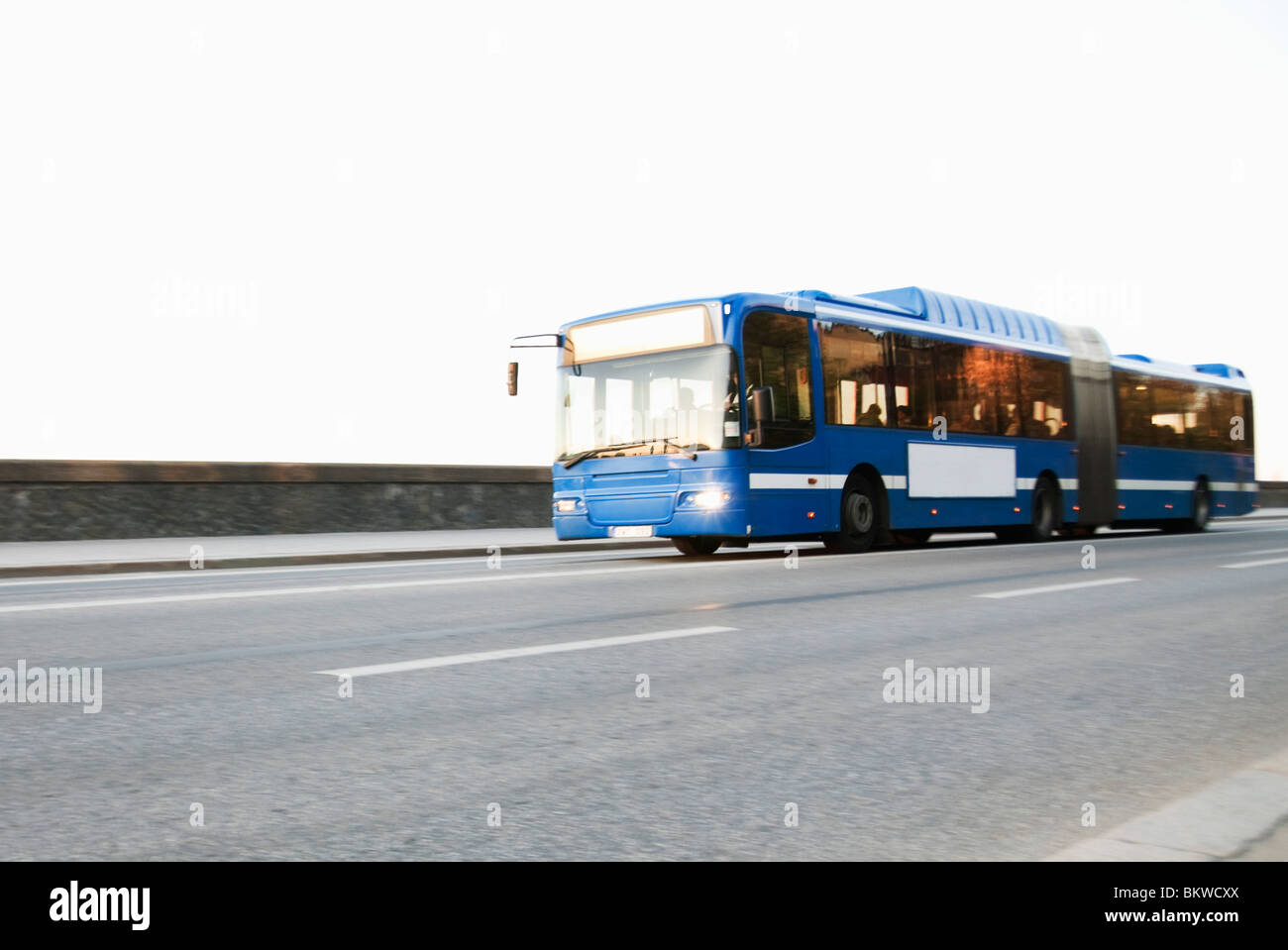 Bus travelling on road Stock Photo - Alamy