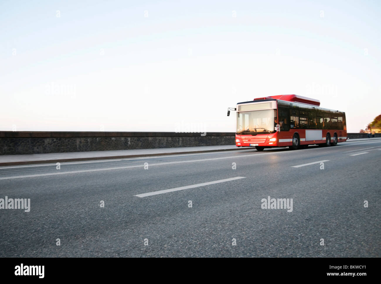 Bus driving on road Stock Photo - Alamy