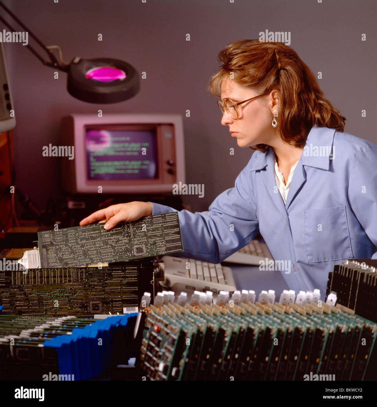 Female technician working in quality control department with printed ...