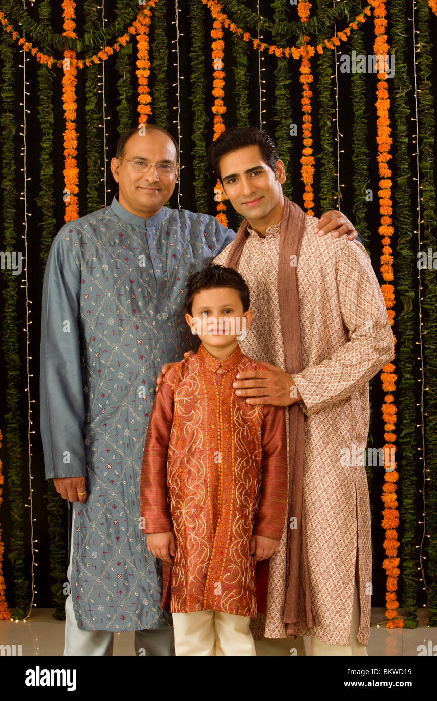 Three generation Indian men standing wearing traditional dress ...