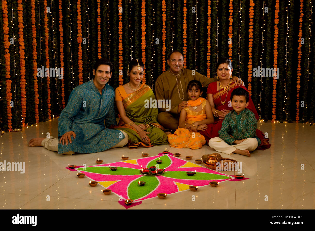 Three generation Indian family in front of rangoli Stock Photo - Alamy