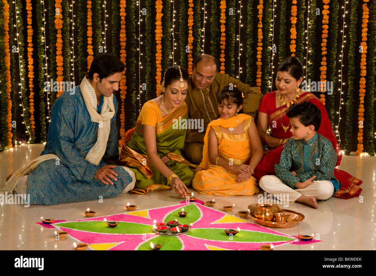 Three generation Indian family in front of rangoli Stock Photo - Alamy