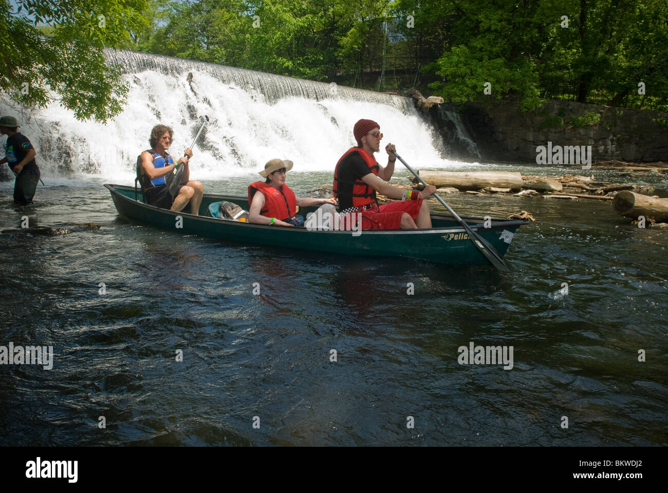 Canoes and kayaks at a portage around a waterfall on the Bronx River in ...