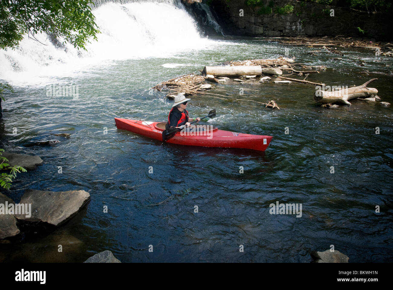 Canoes and kayaks at a portage around a waterfall on the Bronx River in ...