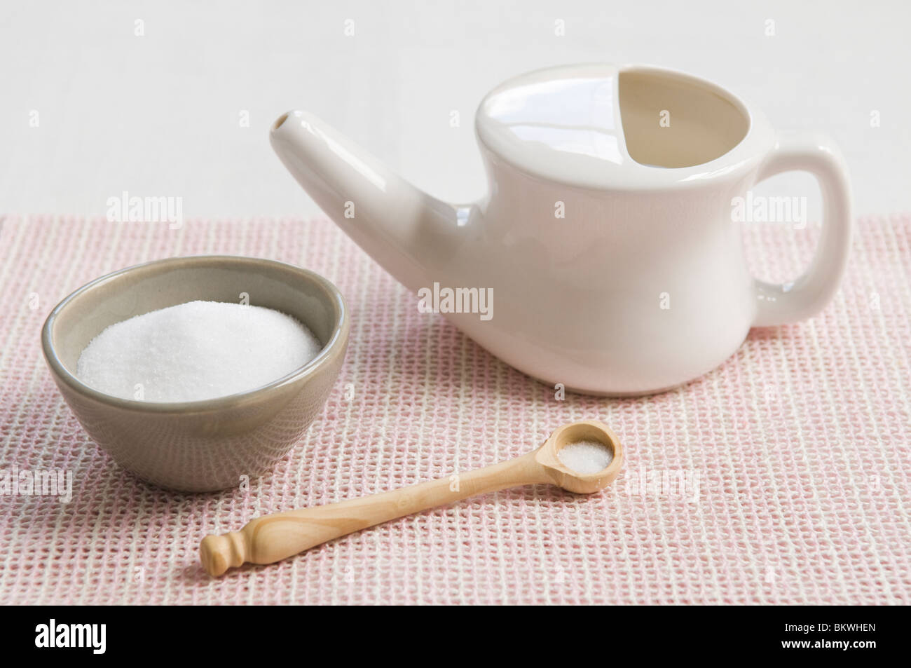 Neti pot with salt and spoon Stock Photo - Alamy