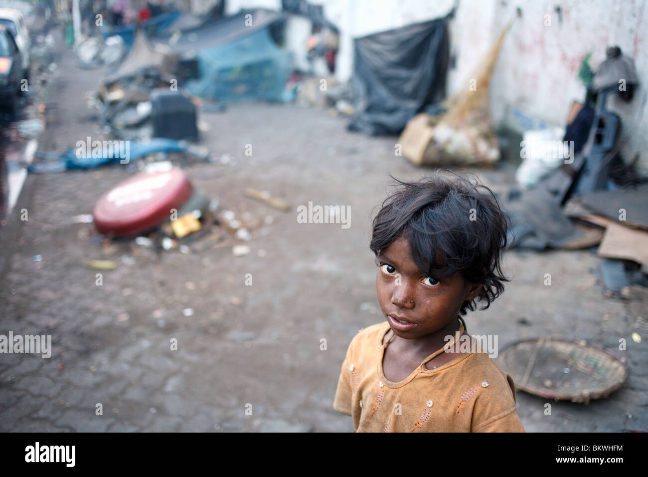 A portrait of a homeless child who lives on a pavement with his family ...