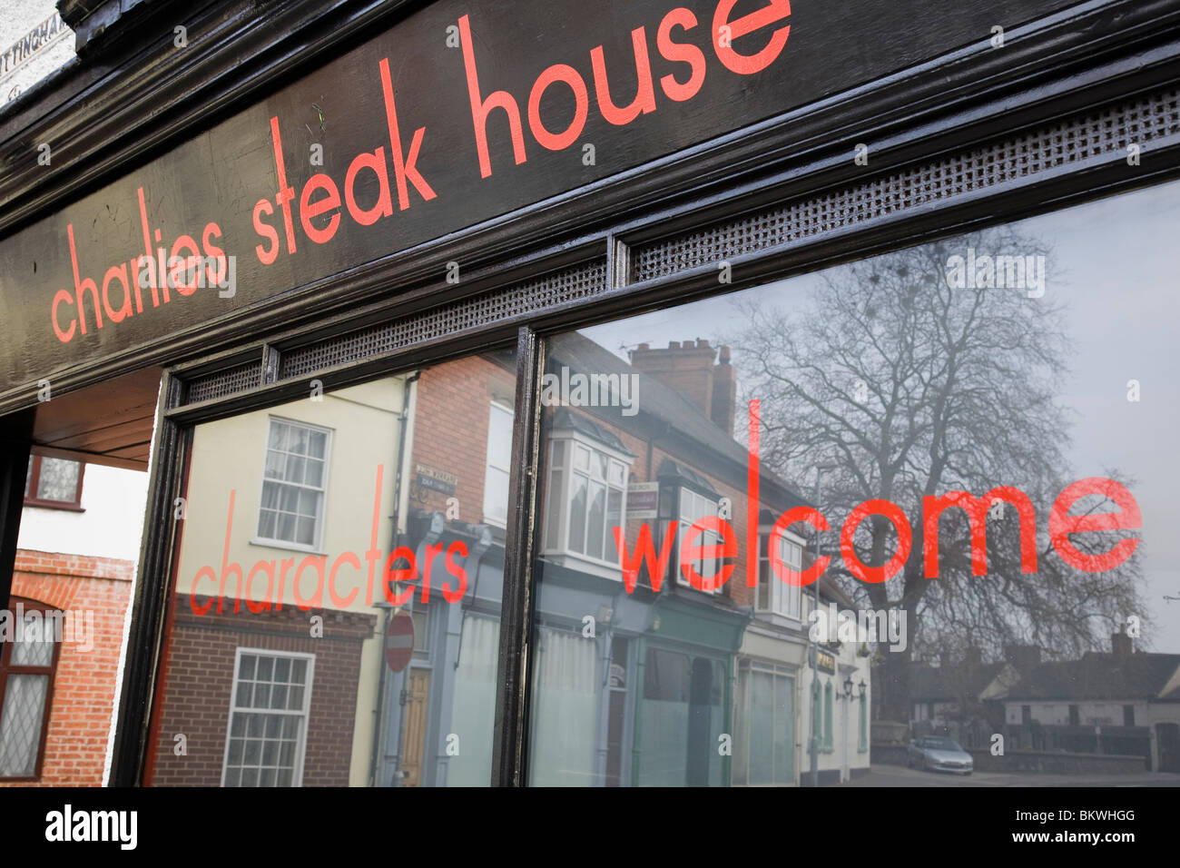 A restaurant shop front with a humerous invitation, England Stock Photo ...