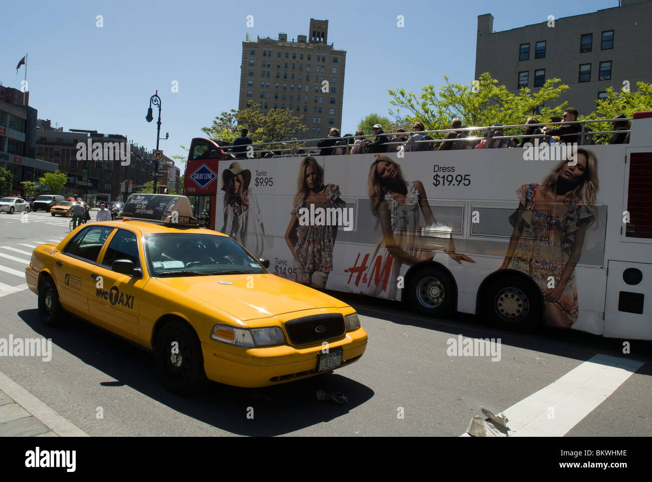 A sightseeing bus bearing advertising for H&M department stores is seen ...