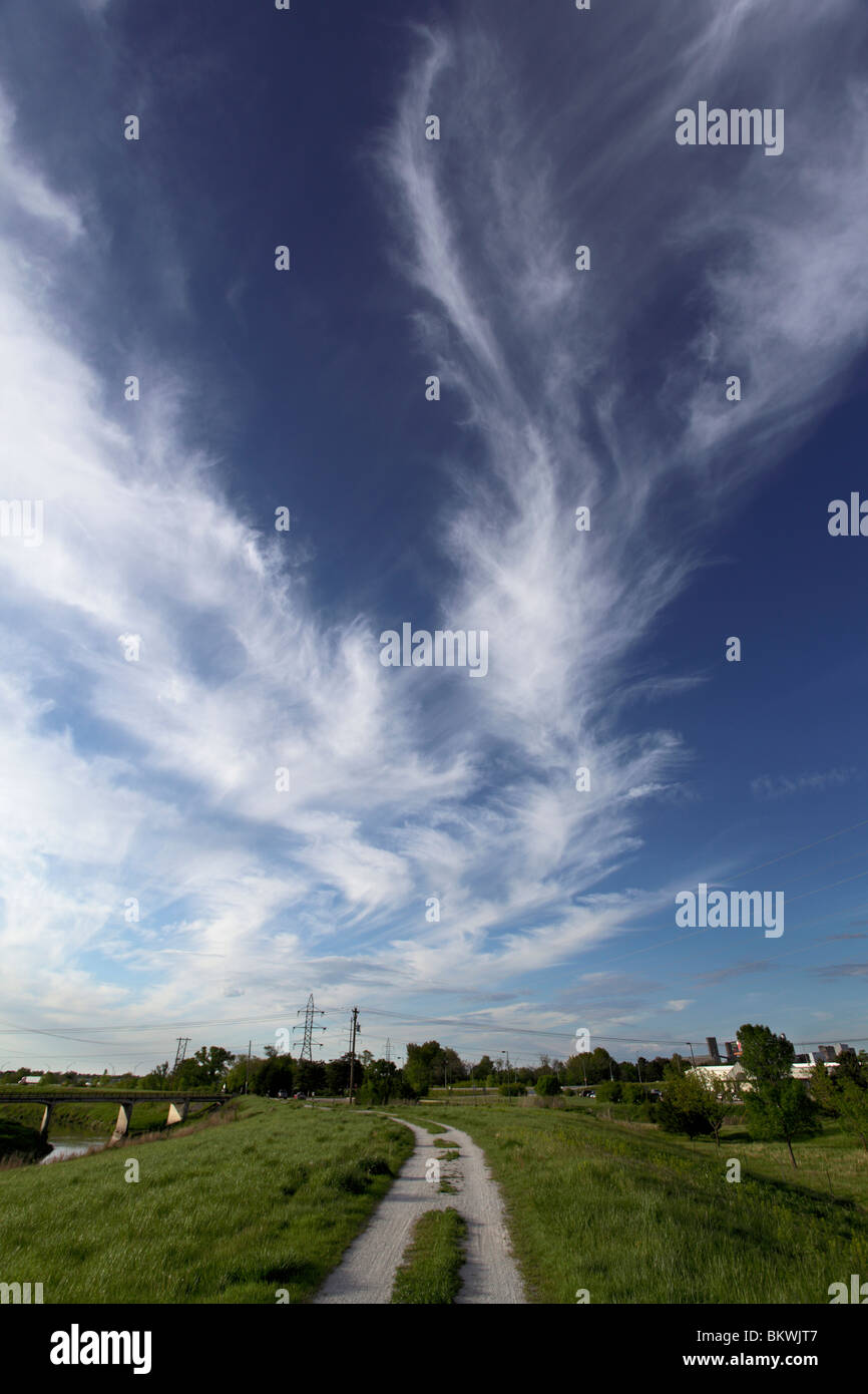 Wispy clouds and double track trail Stock Photo - Alamy