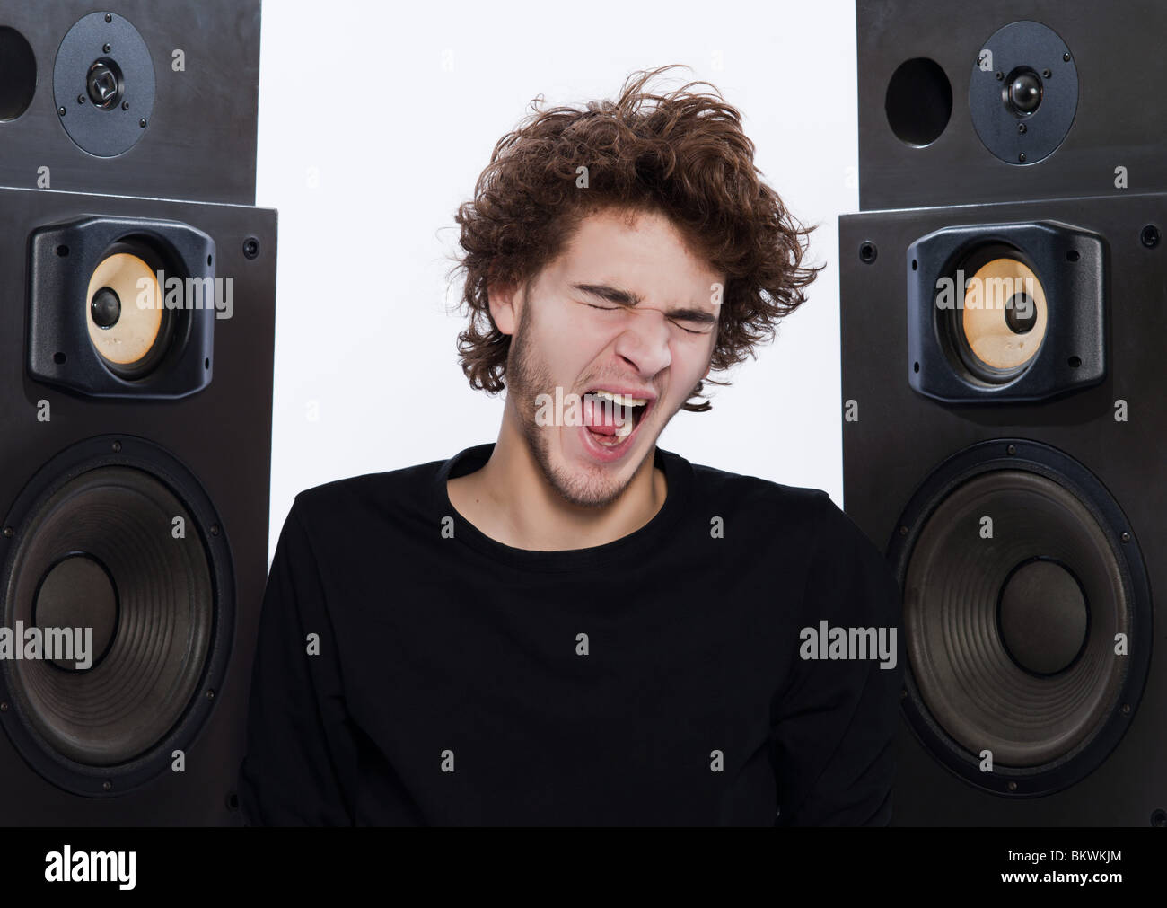 studio portrait of a one caucasian young man listening to music lover ...