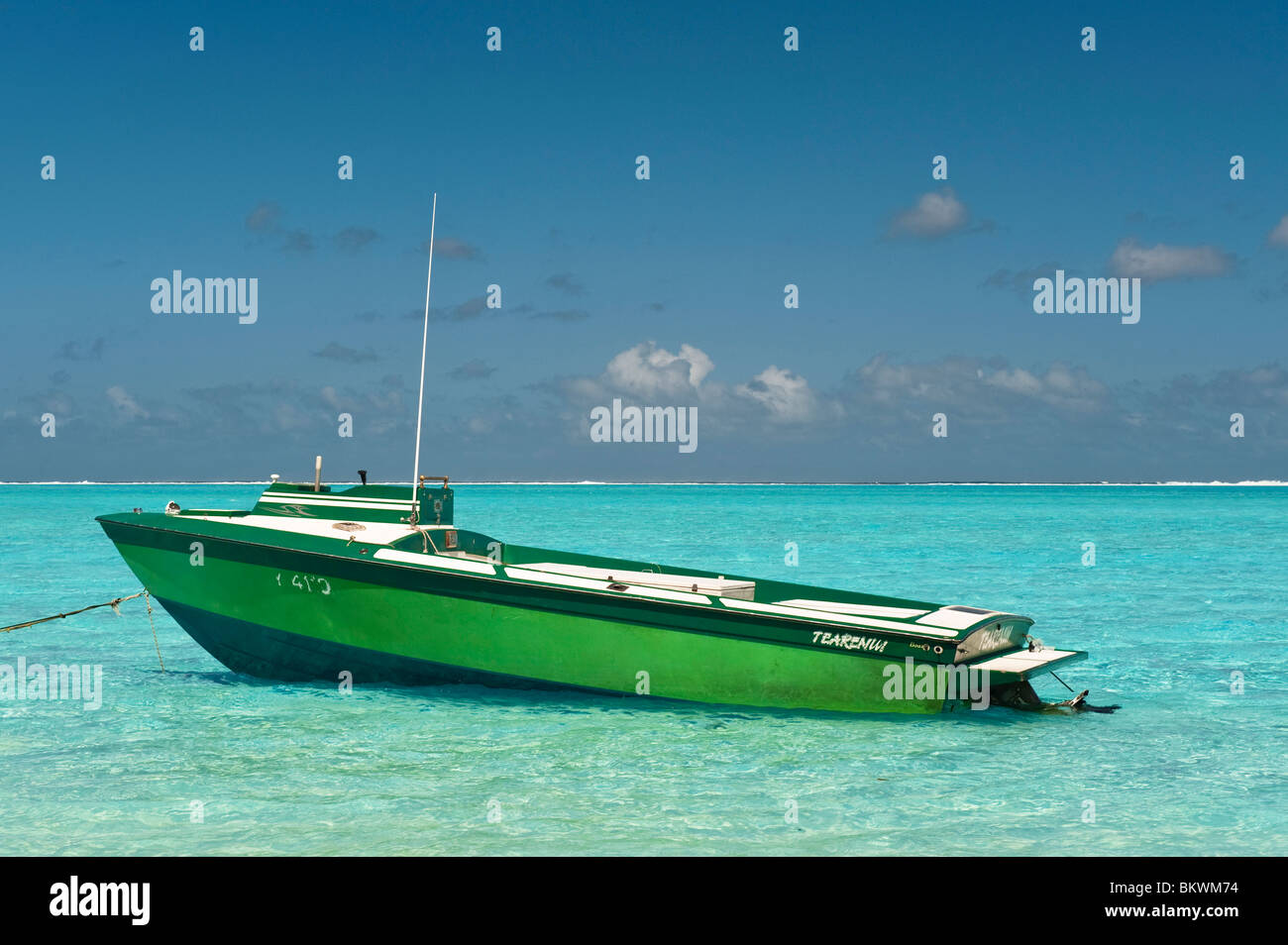 A Green Boat at Anchor in Matira Lagoon and Beach on Bora Bora, French ...