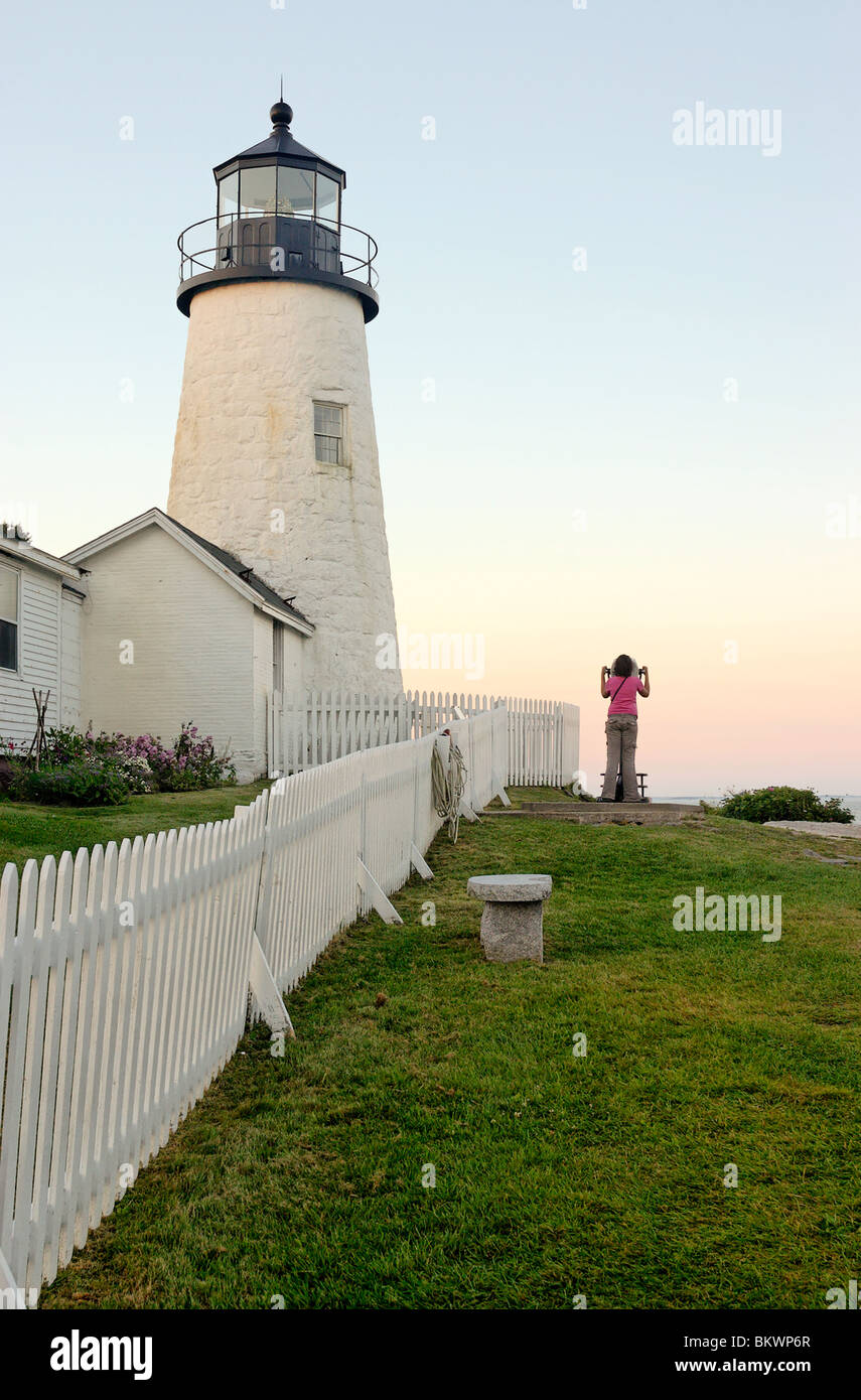Stock photograph of a young girl using telescope at Pemaquid Point ...
