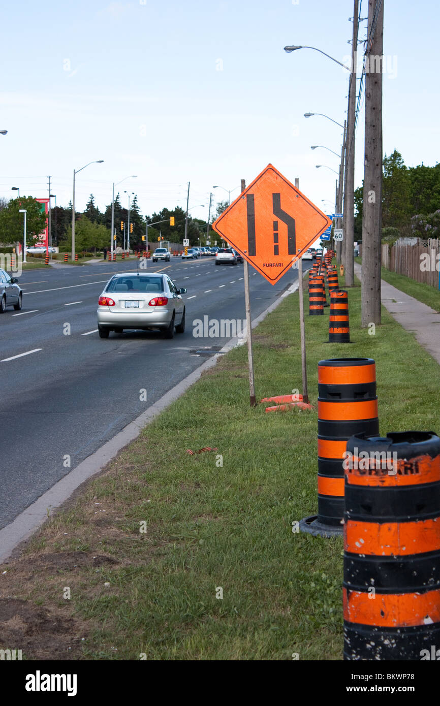 road traffic sign lane end orange car Stock Photo - Alamy