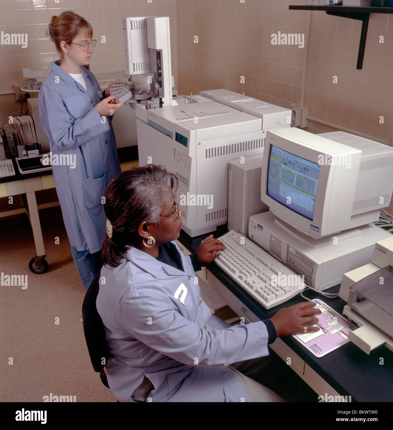 Female African American & Caucasian lab technicians testing water ...
