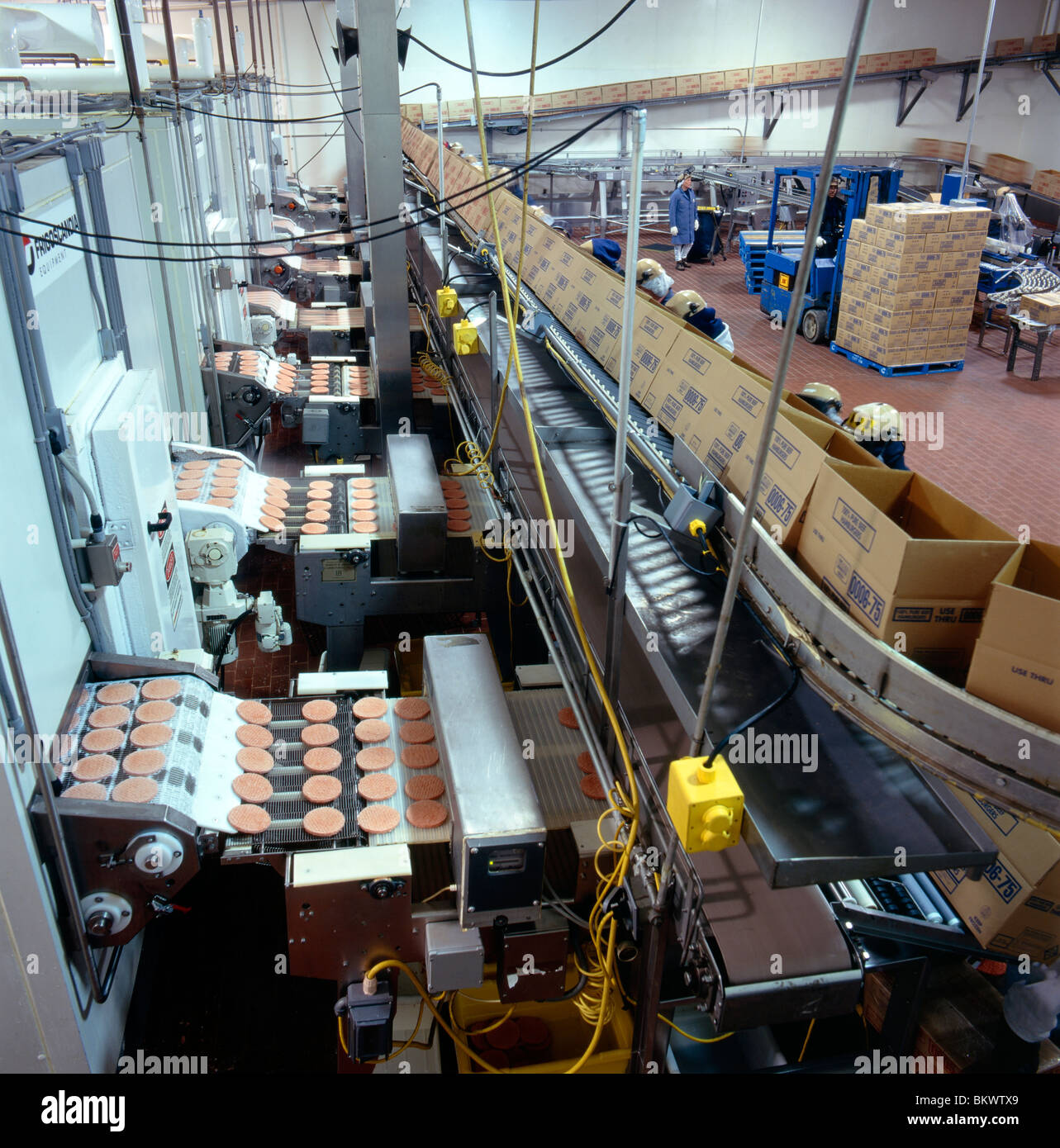 Automated stainless steel assembly line produces hamburger patties for ...
