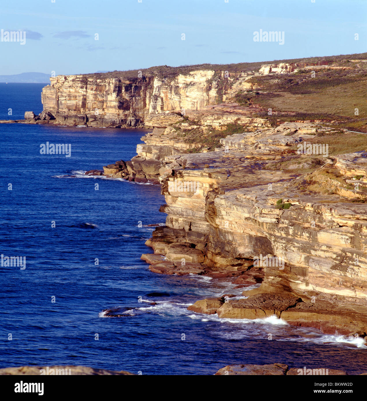 Sunrise over the Pacific Ocean and sandstone cliffs at Royal National ...