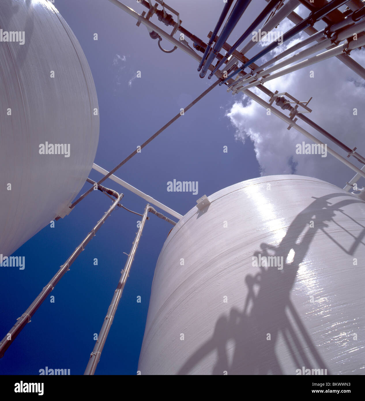 Large white chemical tanks at an industrial manufacturing plant in ...