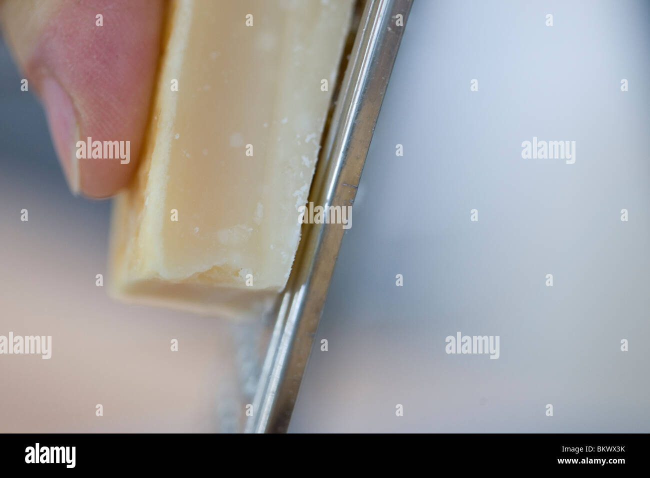 Grating parmesan cheese Stock Photo - Alamy