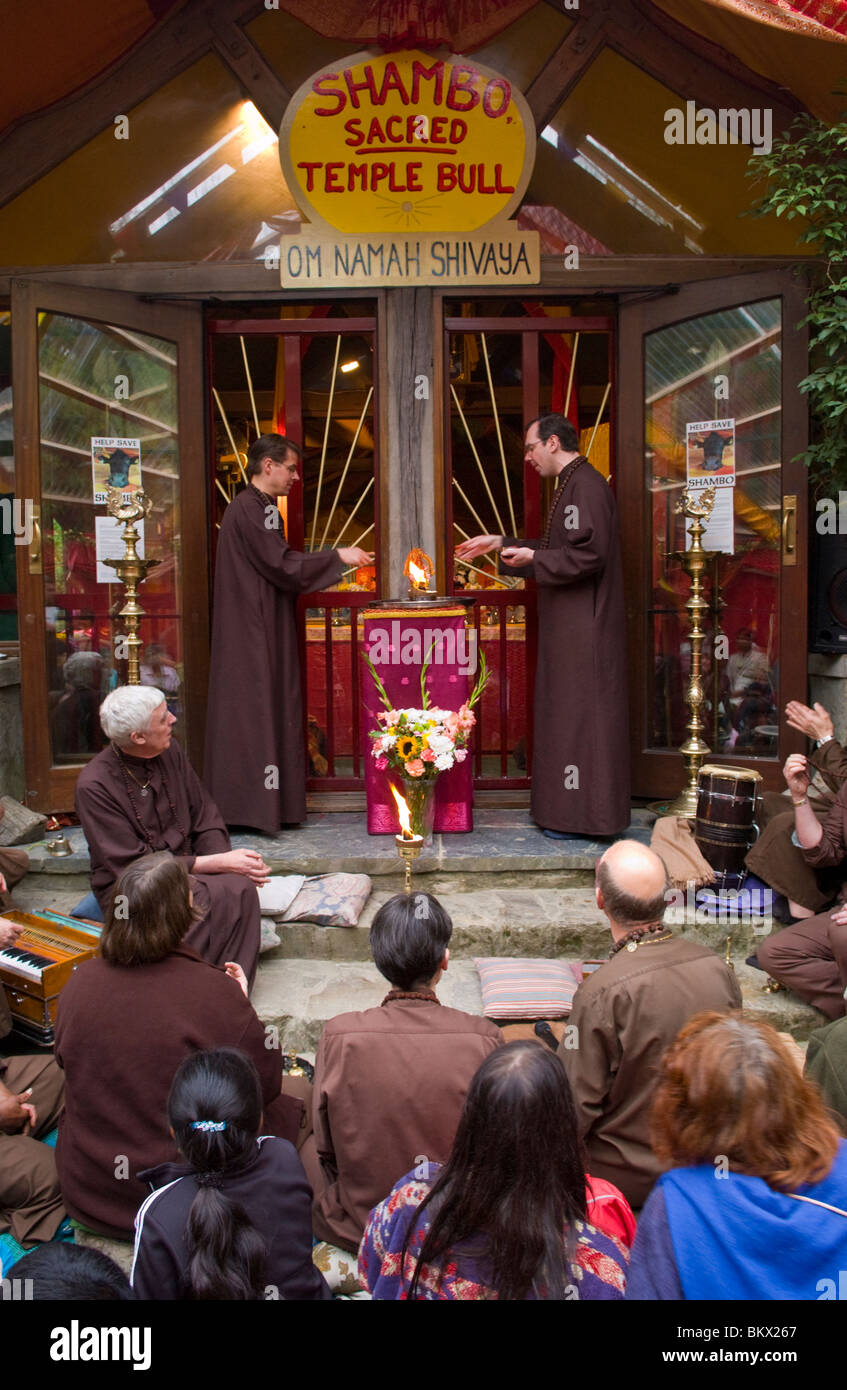 Monks and visitors chanting and praying outside the stall of sacred ...
