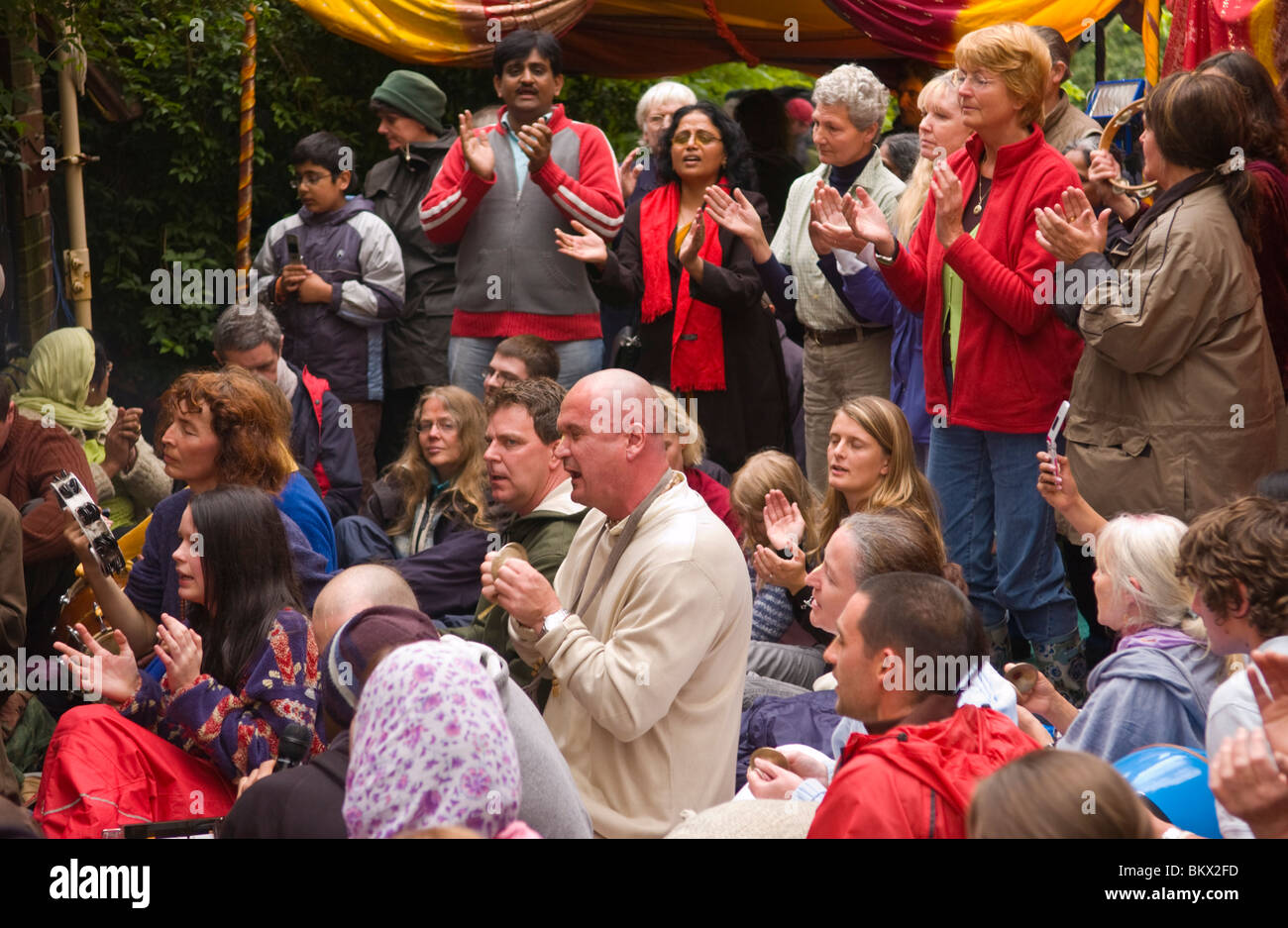 Monks and visitors chanting and praying outside the stall of sacred ...