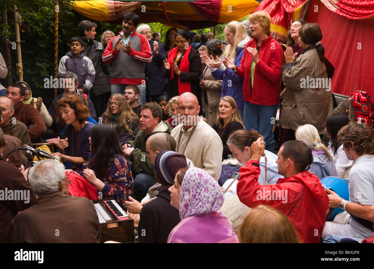Monks and visitors chanting and praying outside the stall of sacred ...