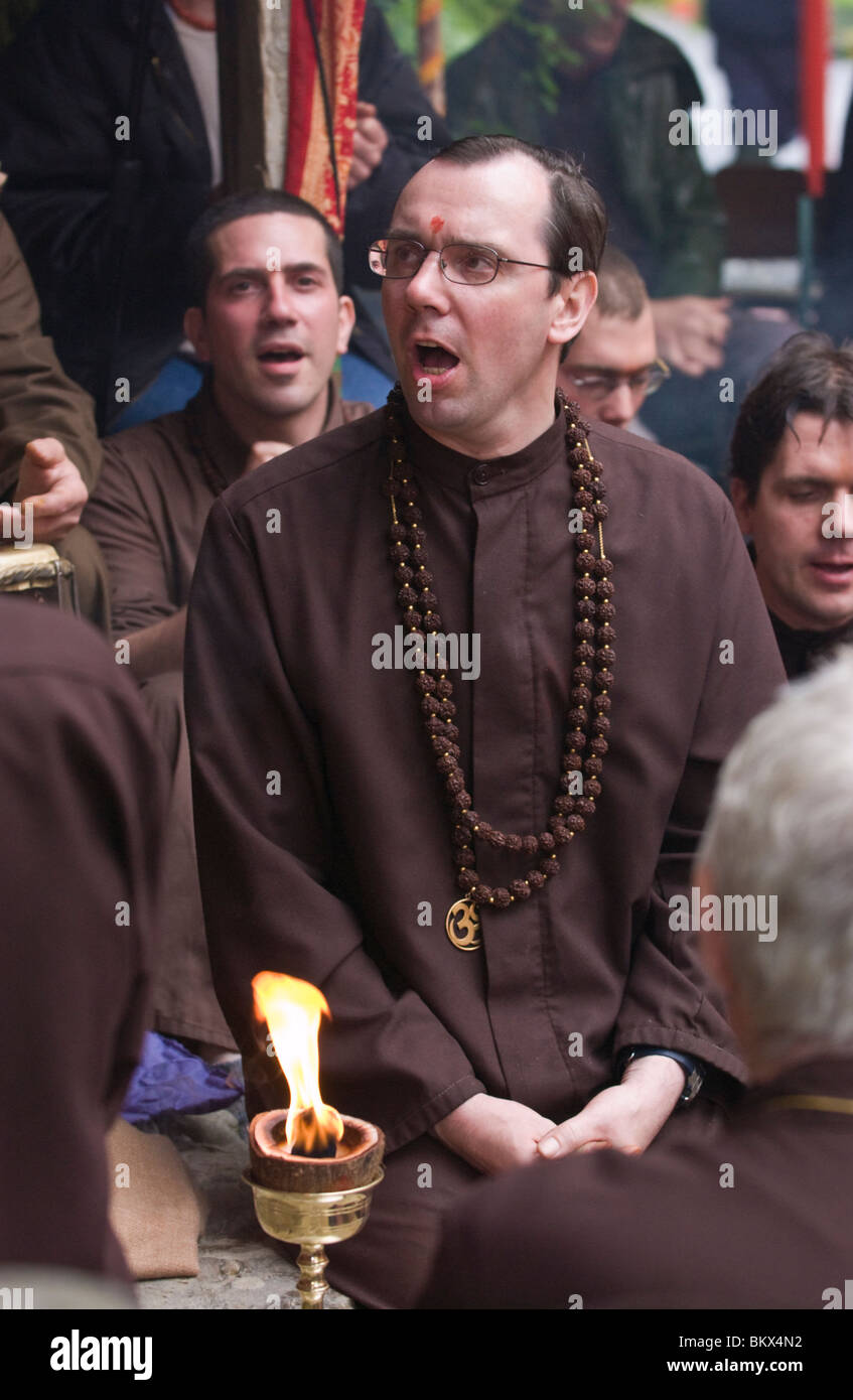 Hindu monks chanting and praying outside the stall of sacred bull ...