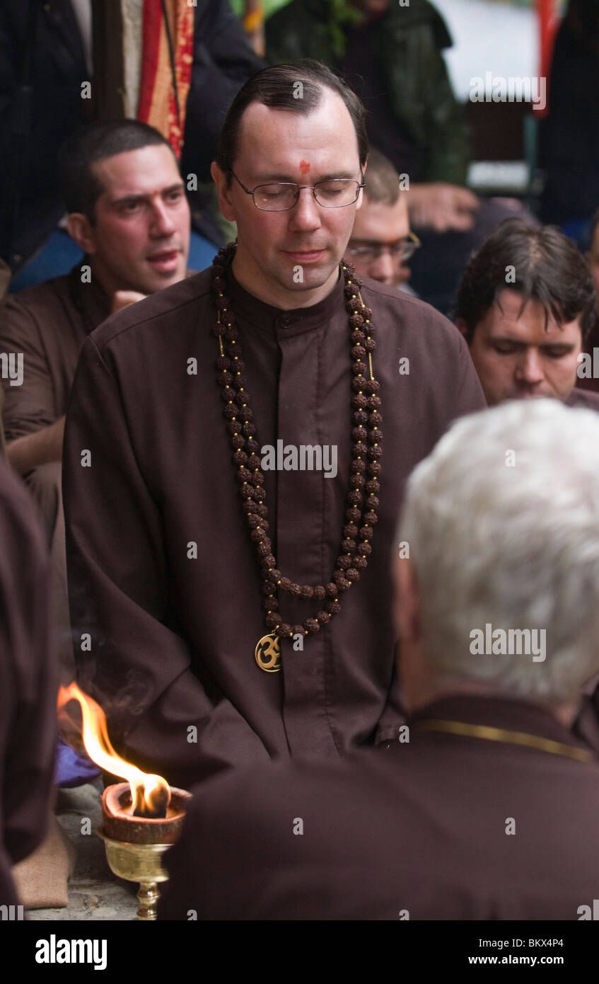 Hindu monks chanting and praying outside the stall of sacred bull ...
