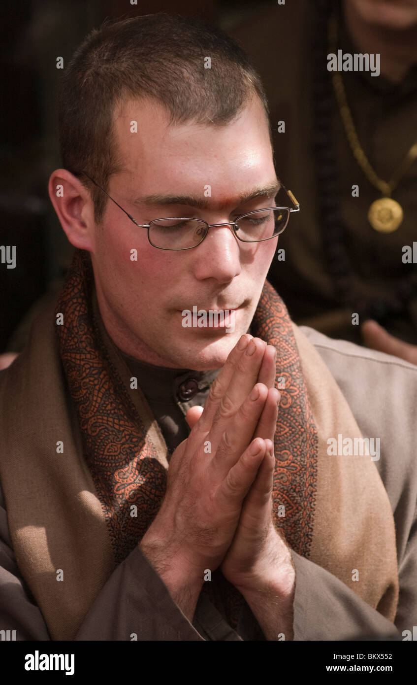 Hindu monks chanting and praying outside the stall of sacred bull ...