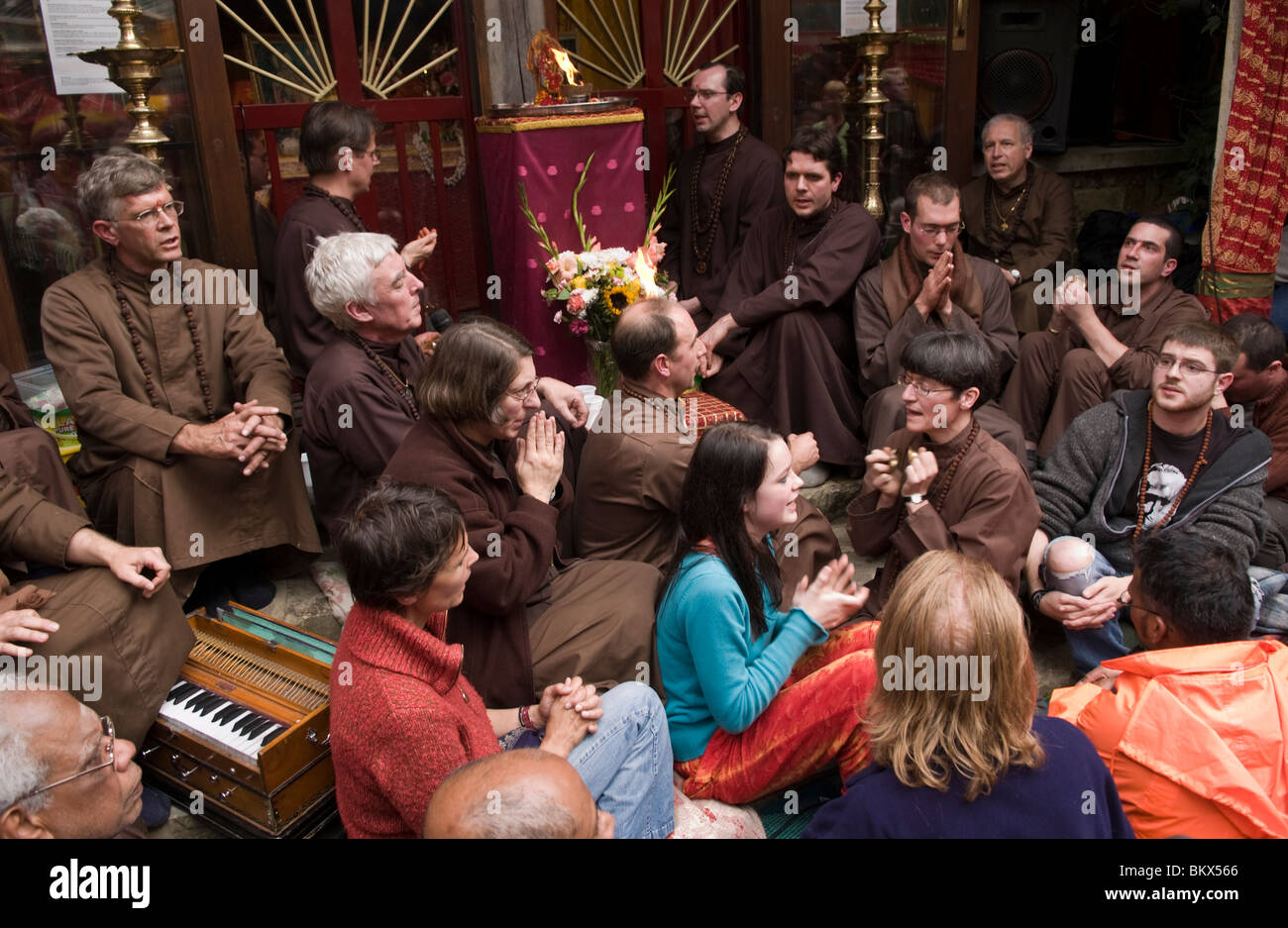 Monks and visitors chanting and praying outside the stall of sacred ...