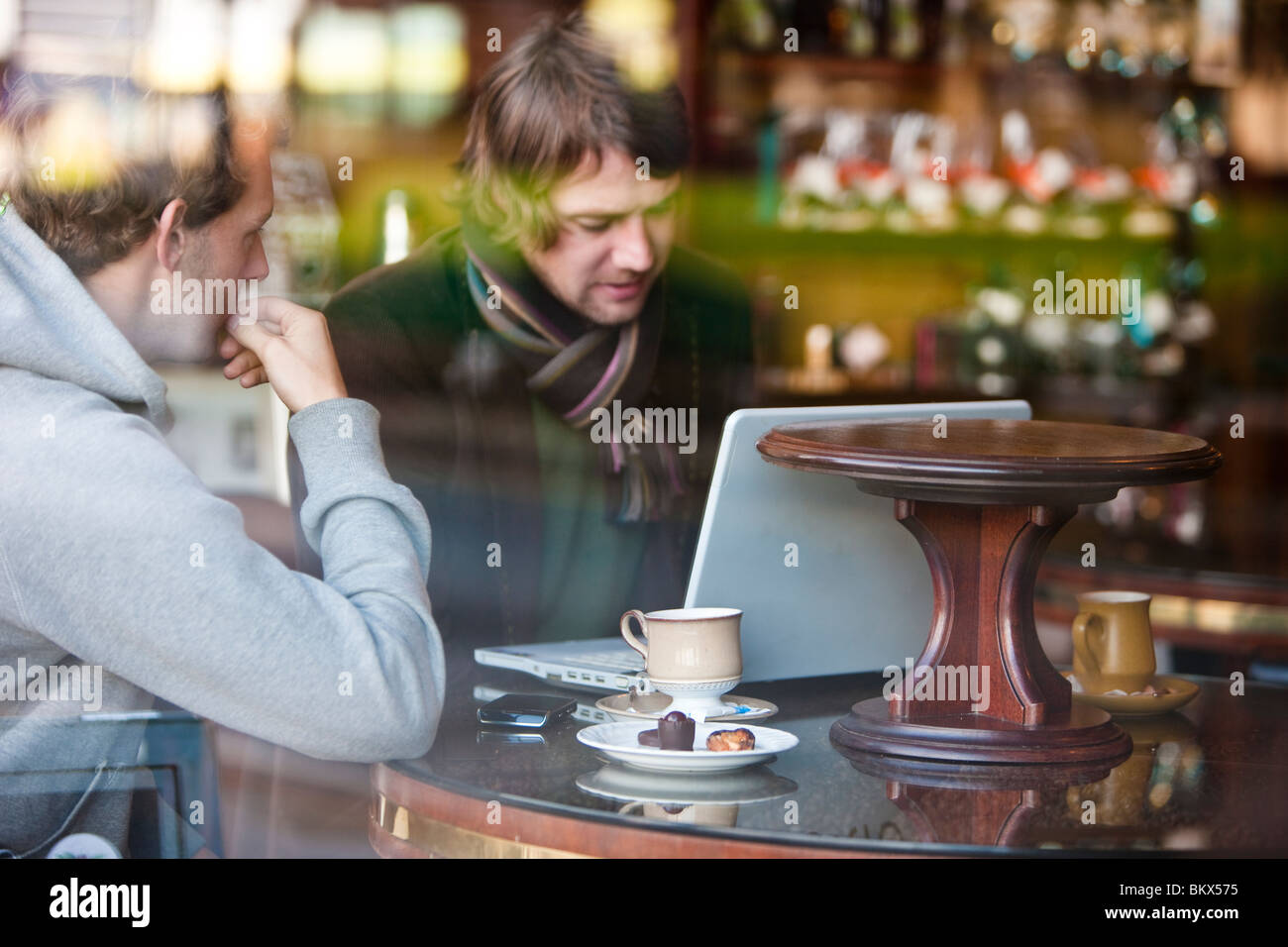 Two men talking in a cafe Stock Photo - Alamy