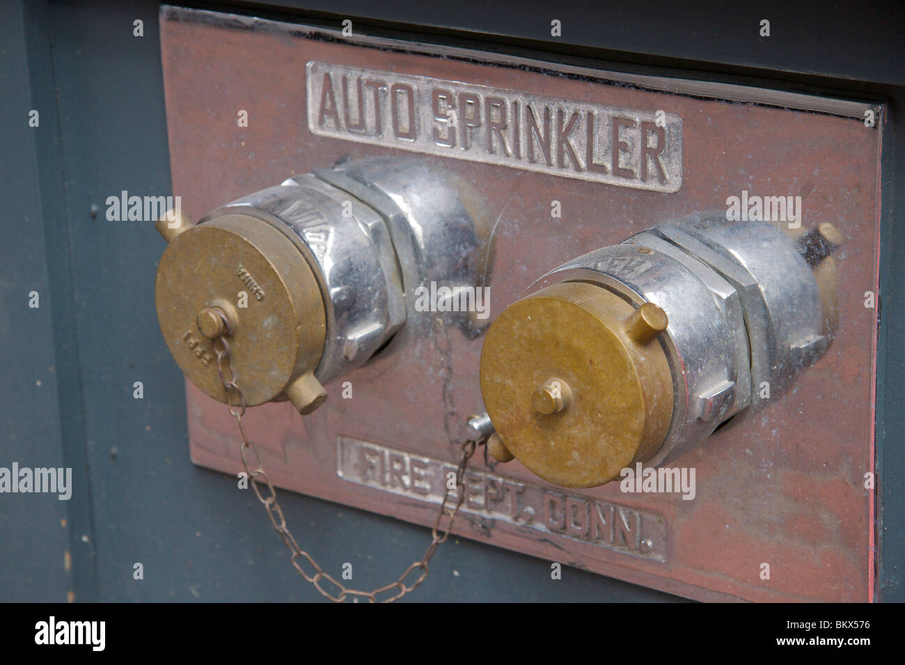Metal double fire hydrant and auto sprinkler in wall of building in ...