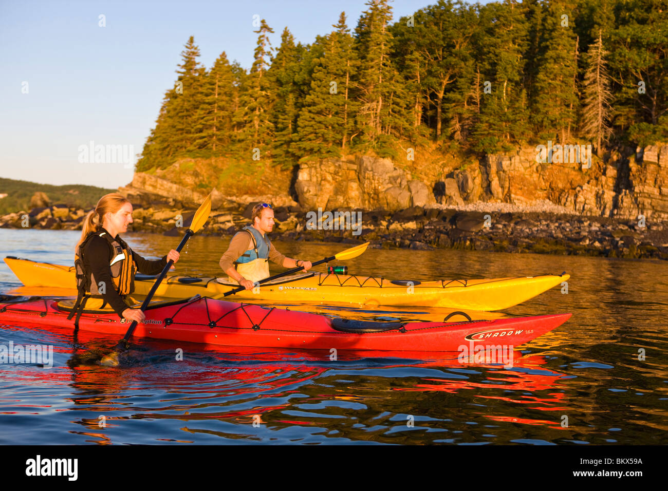 A man and woman sea kayaking near Sheep Porcupine Island in Maine's ...