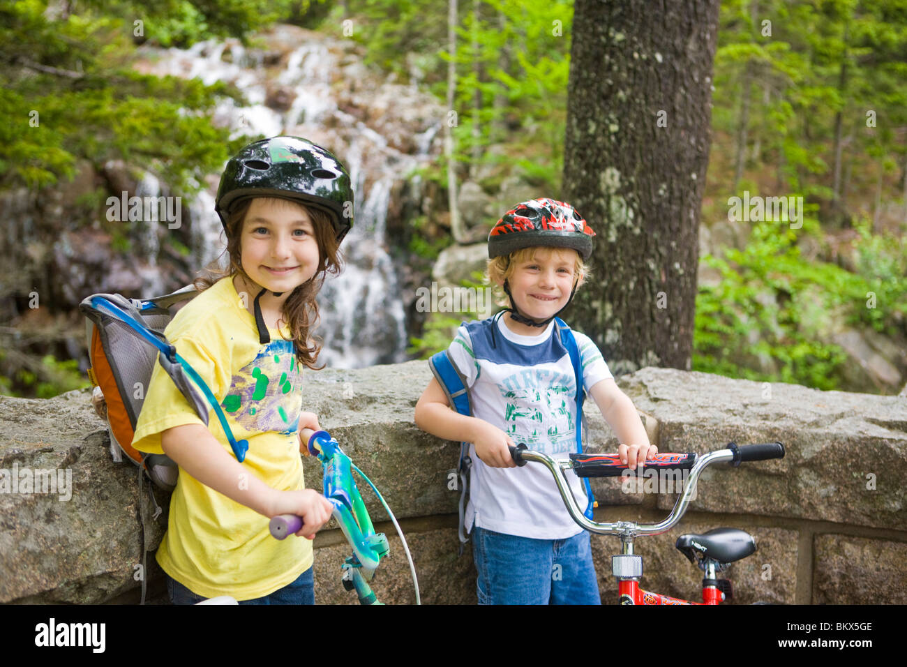 two young bike riders on a carriage road in Maine's Acadia National ...