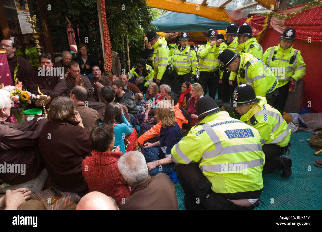 Police officers remove peaceful sit down protesters at Skanda Vale ...