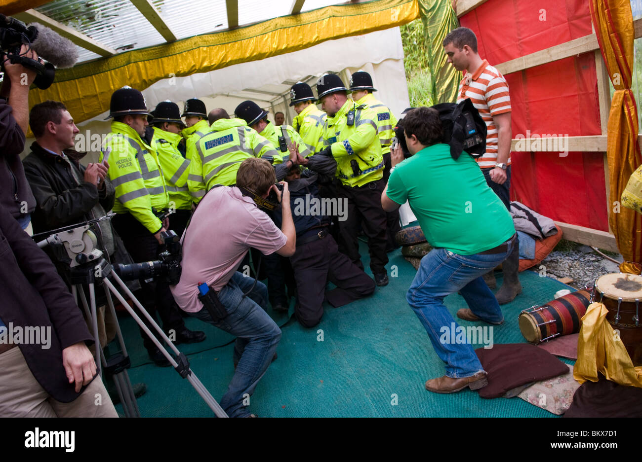 Police officers remove peaceful sit down protesters at Skanda Vale ...