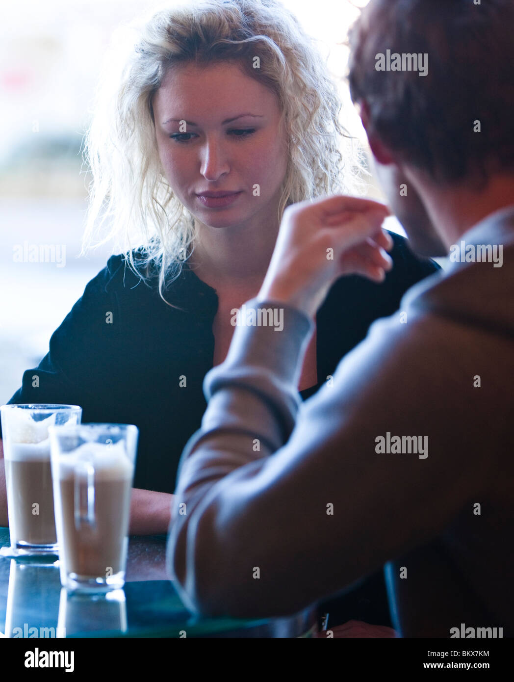 Couple having serious conversation in hi-res stock photography and ...