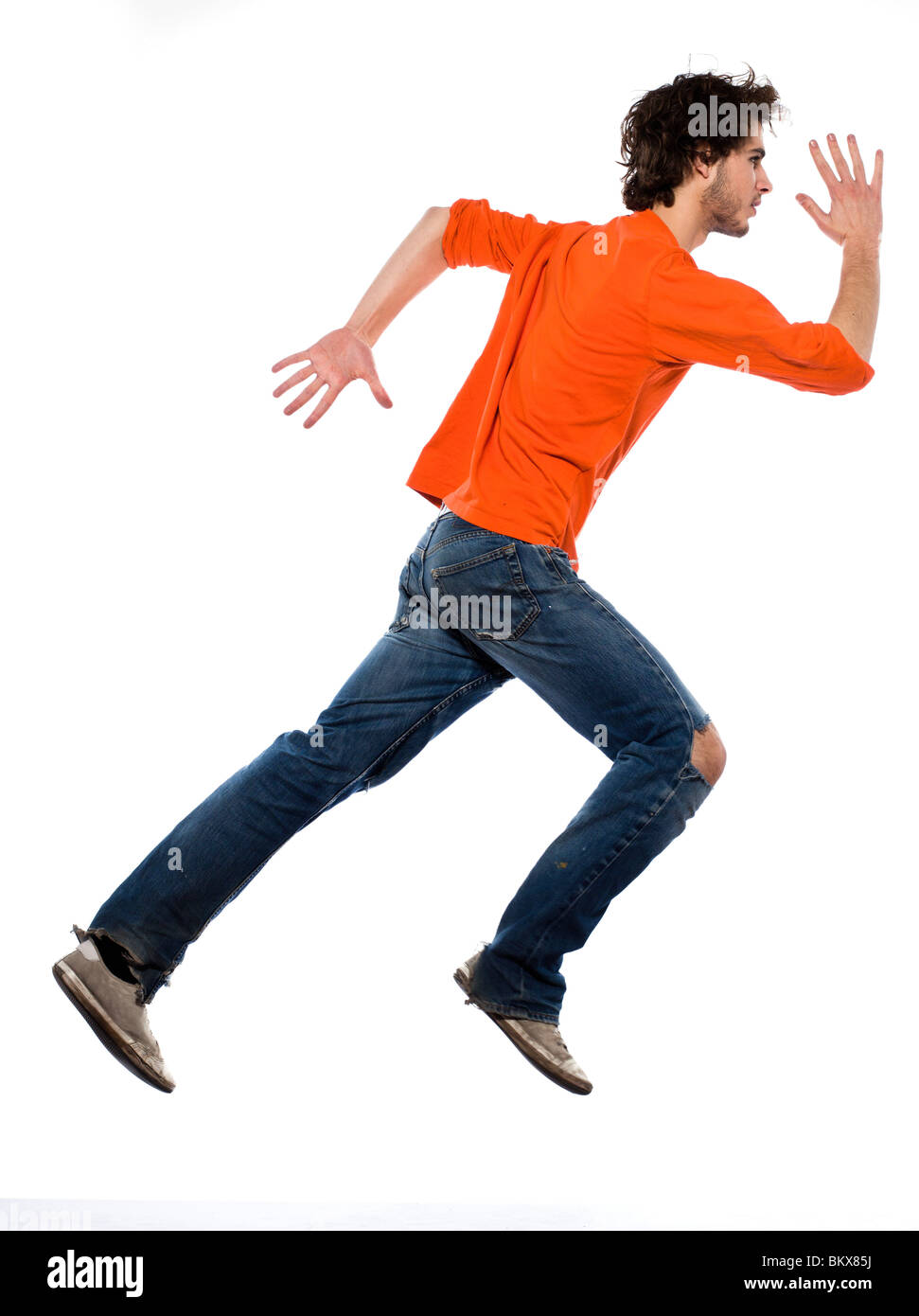 young running caucasian man portrait in studio on white background ...